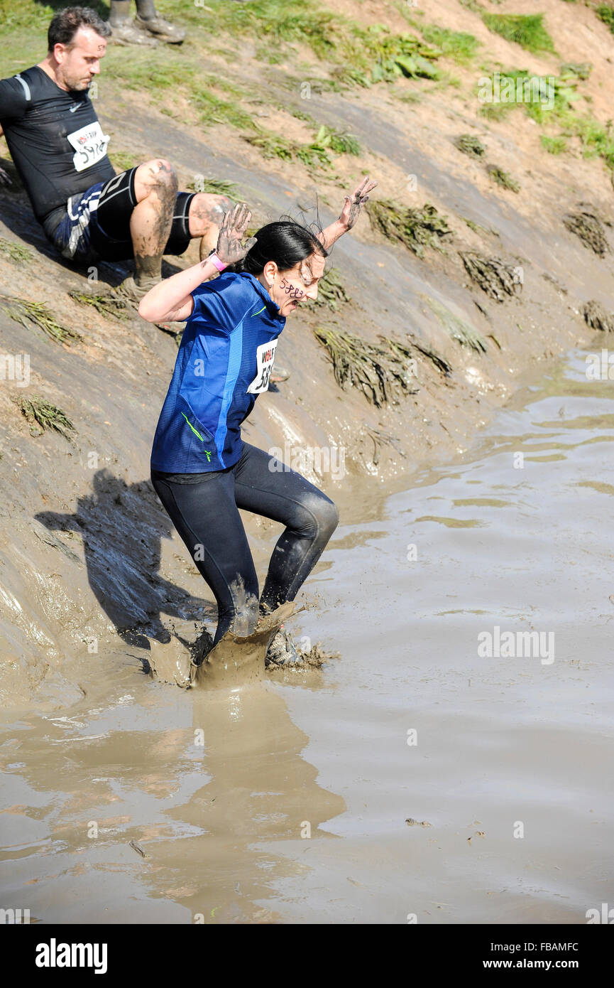 Mud covered single female runners at obstacle course race, UK Stock ...