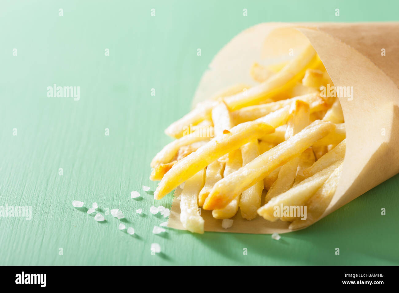 french fries over green background Stock Photo - Alamy