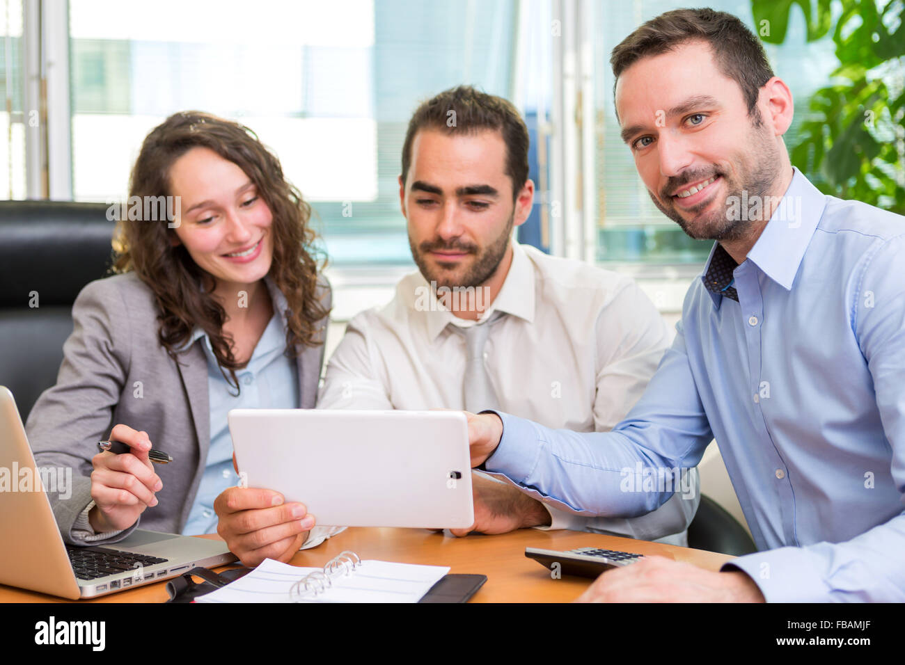 View of a Group of business associates working together at the office ...
