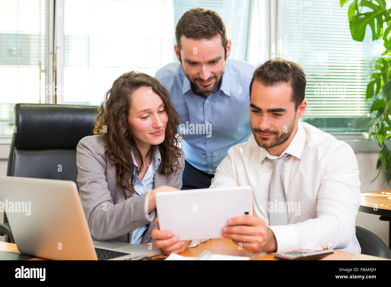 View of a Group of business associates working together at the office ...