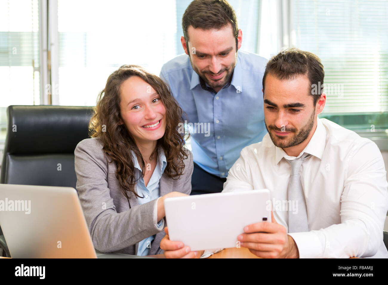 View of a Group of business associates working together at the office ...