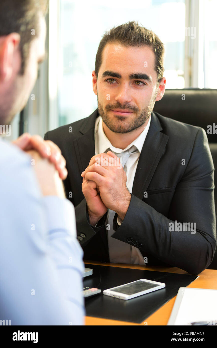 View of a Attractive boss doing interview with his assistant Stock ...