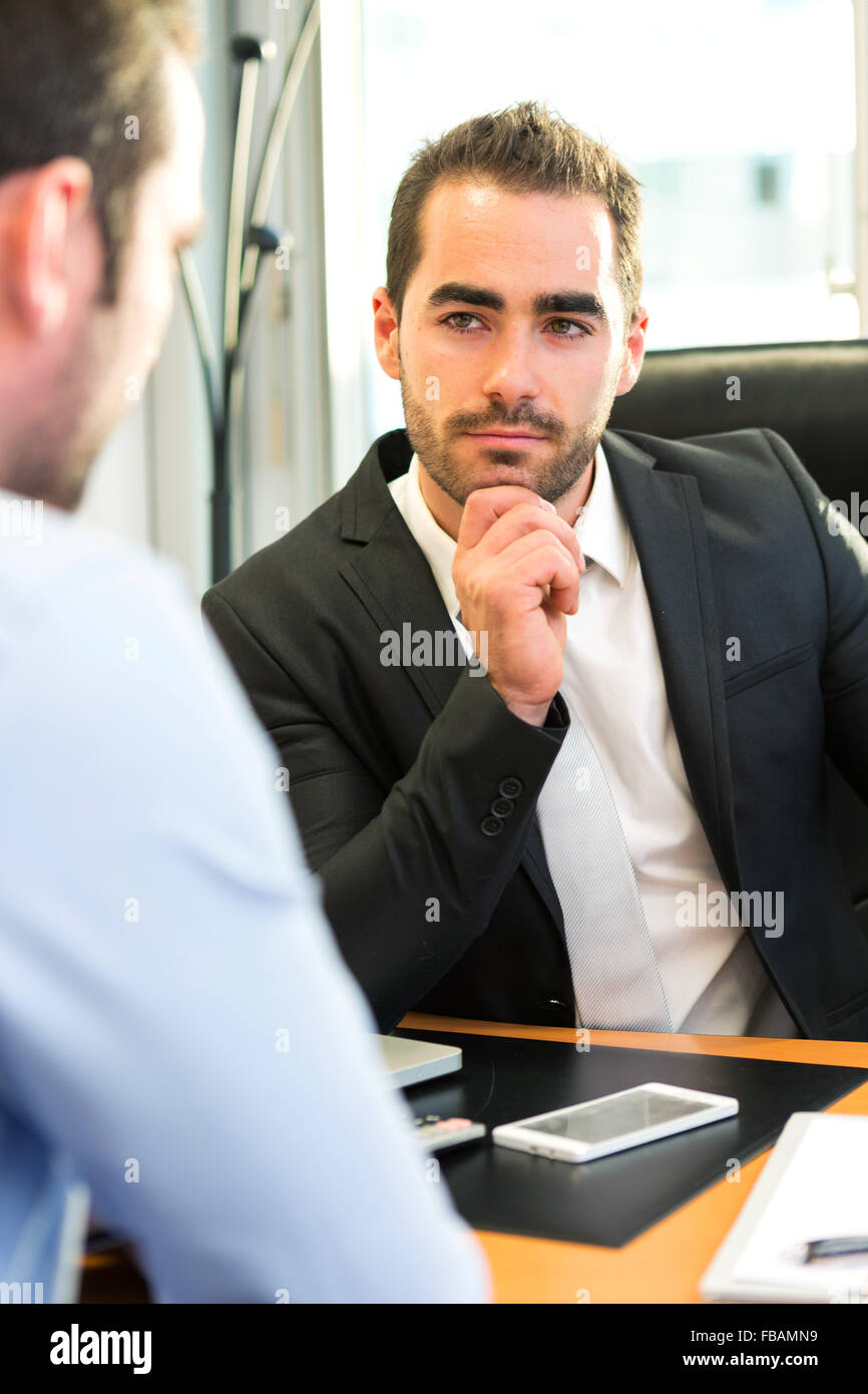 View of a Attractive boss doing interview with his assistant Stock ...