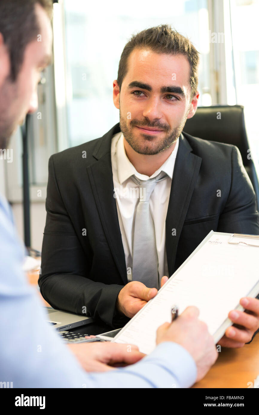 View of a Attractive boss doing interview with his assistant Stock ...