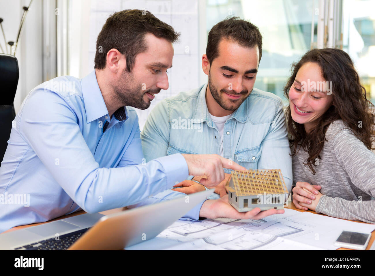 View of a Young attractive people meeting real estate agent at the ...