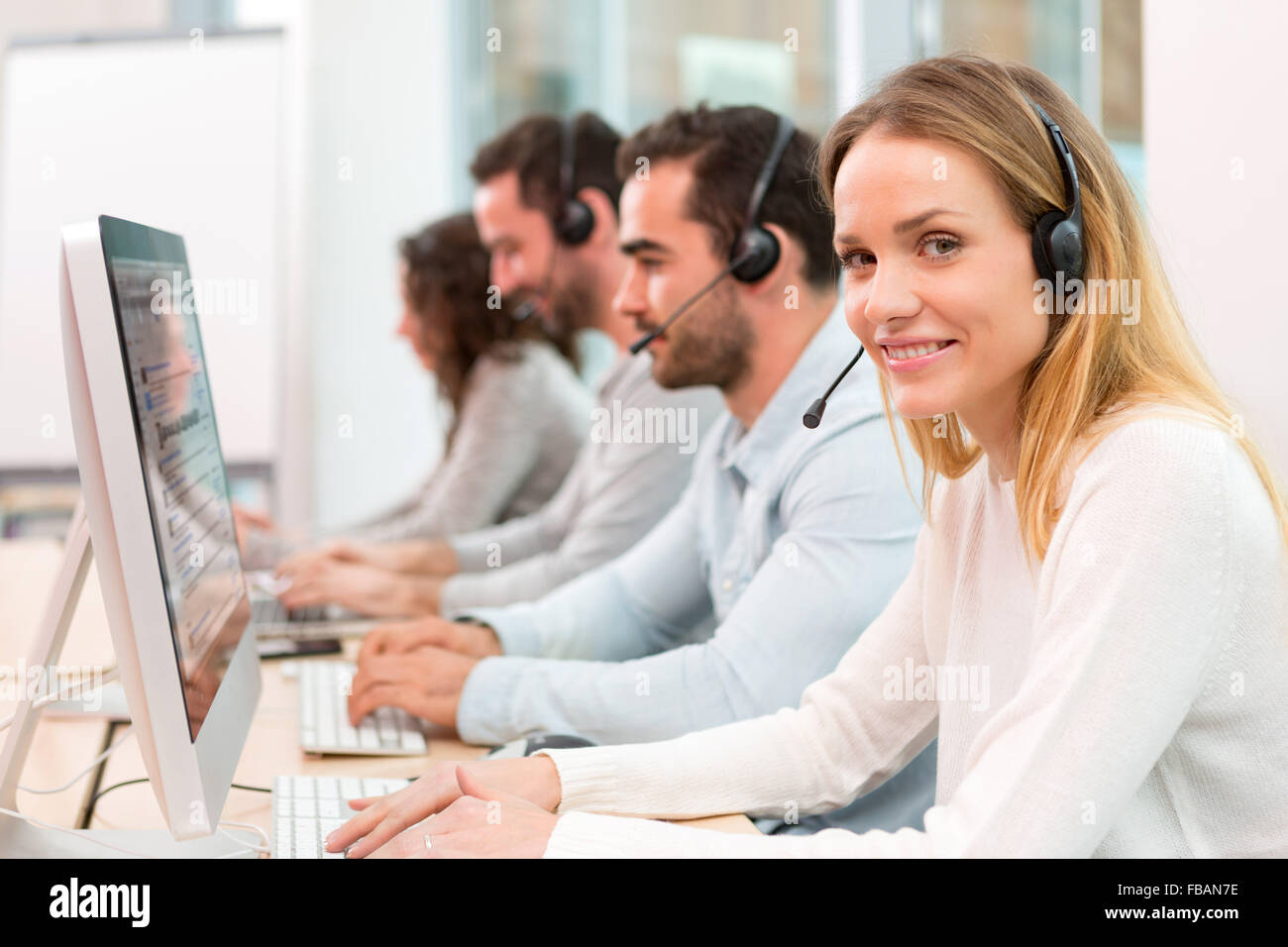 View of a Young attractive woman working in a call center Stock Photo ...