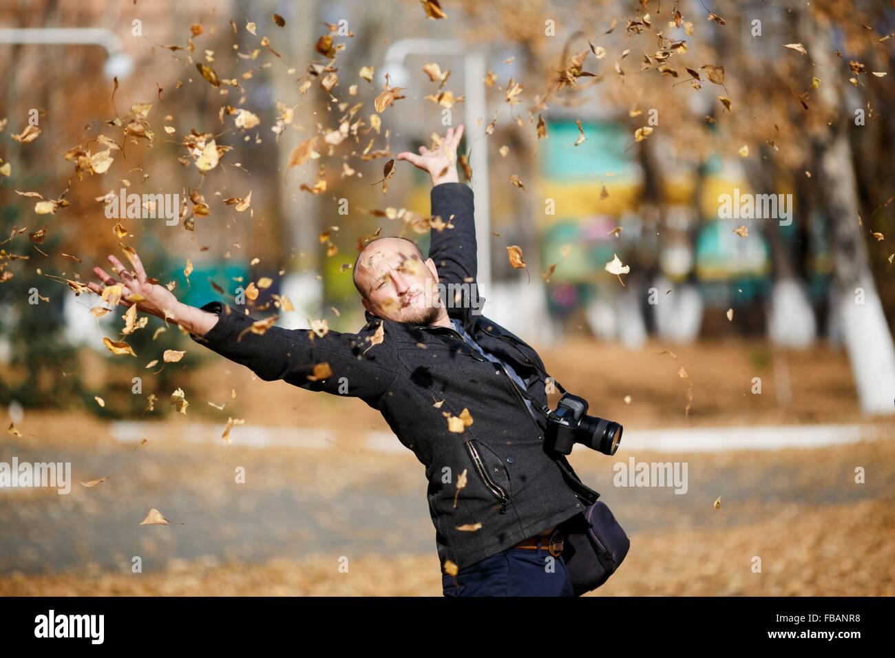 Portrait happy bald man photographer with professional digital camera ...