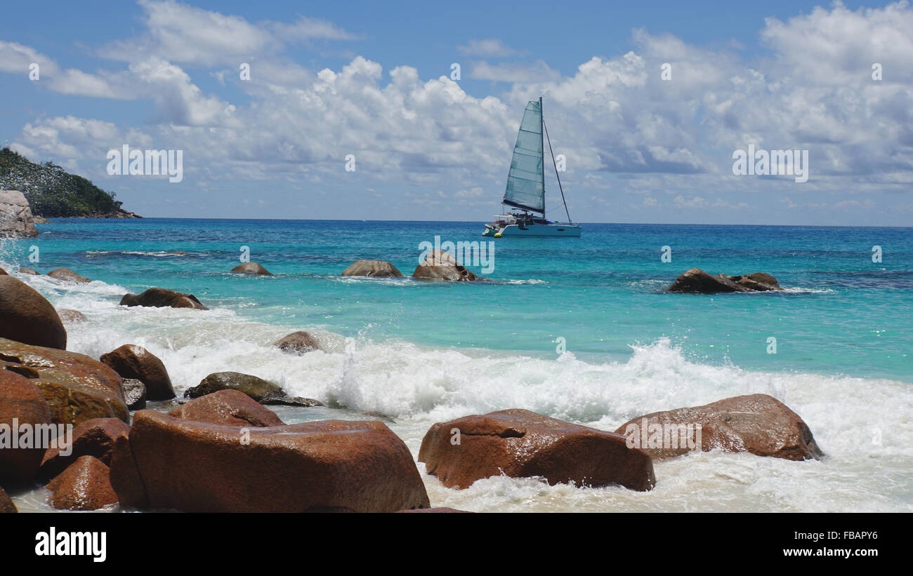 tropical beach with granite rocks and boat Stock Photo - Alamy