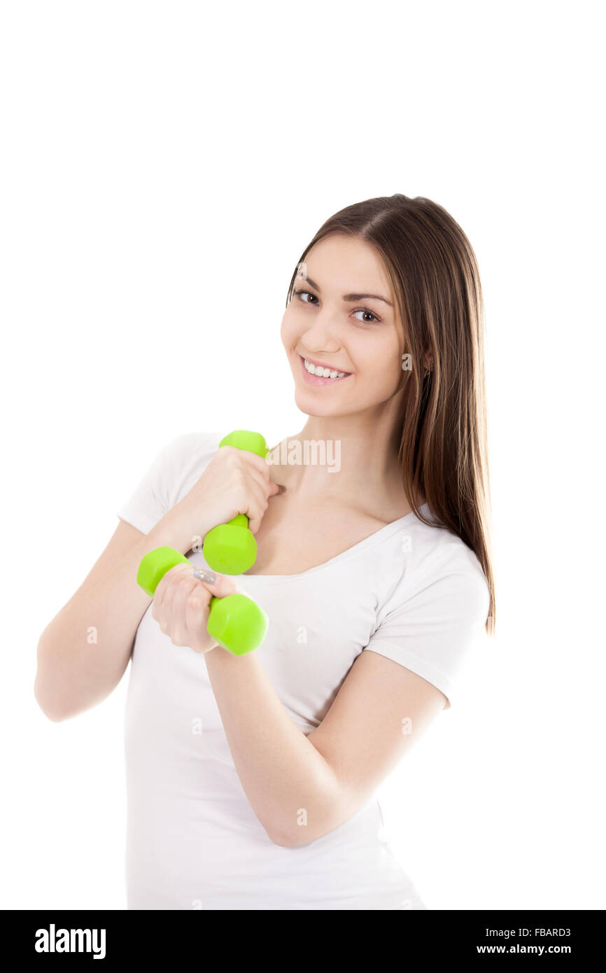Young smiling woman in white t-shirt holding, lifting weights, workout ...