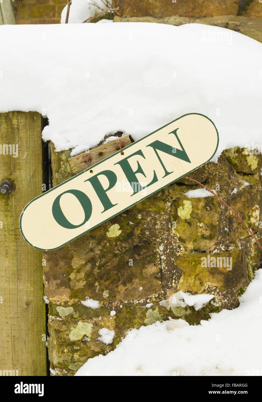 Open sign on gate of cafe in Yorkshire during heavy snow Stock Photo ...
