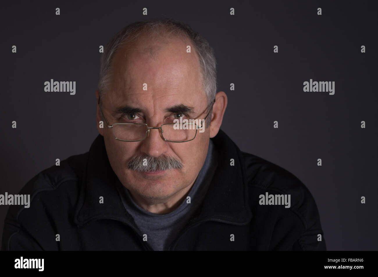 Portrait of a thoughtful Caucasian man against dark background Stock ...
