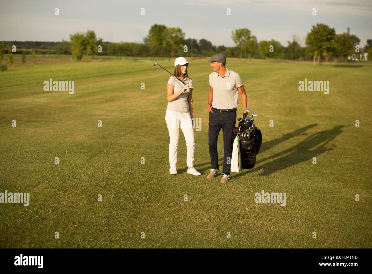 Young couple at golf court Stock Photo - Alamy