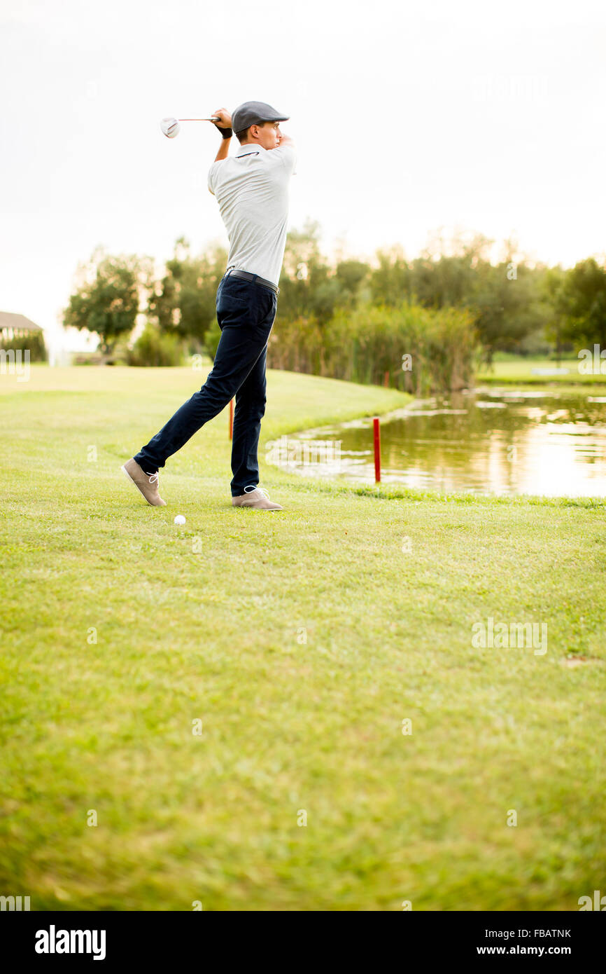 Young man playing golf Stock Photo - Alamy