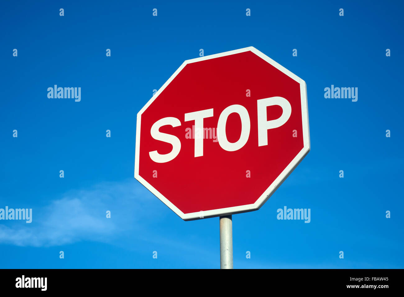 Red stop sign against a blue sky Stock Photo - Alamy