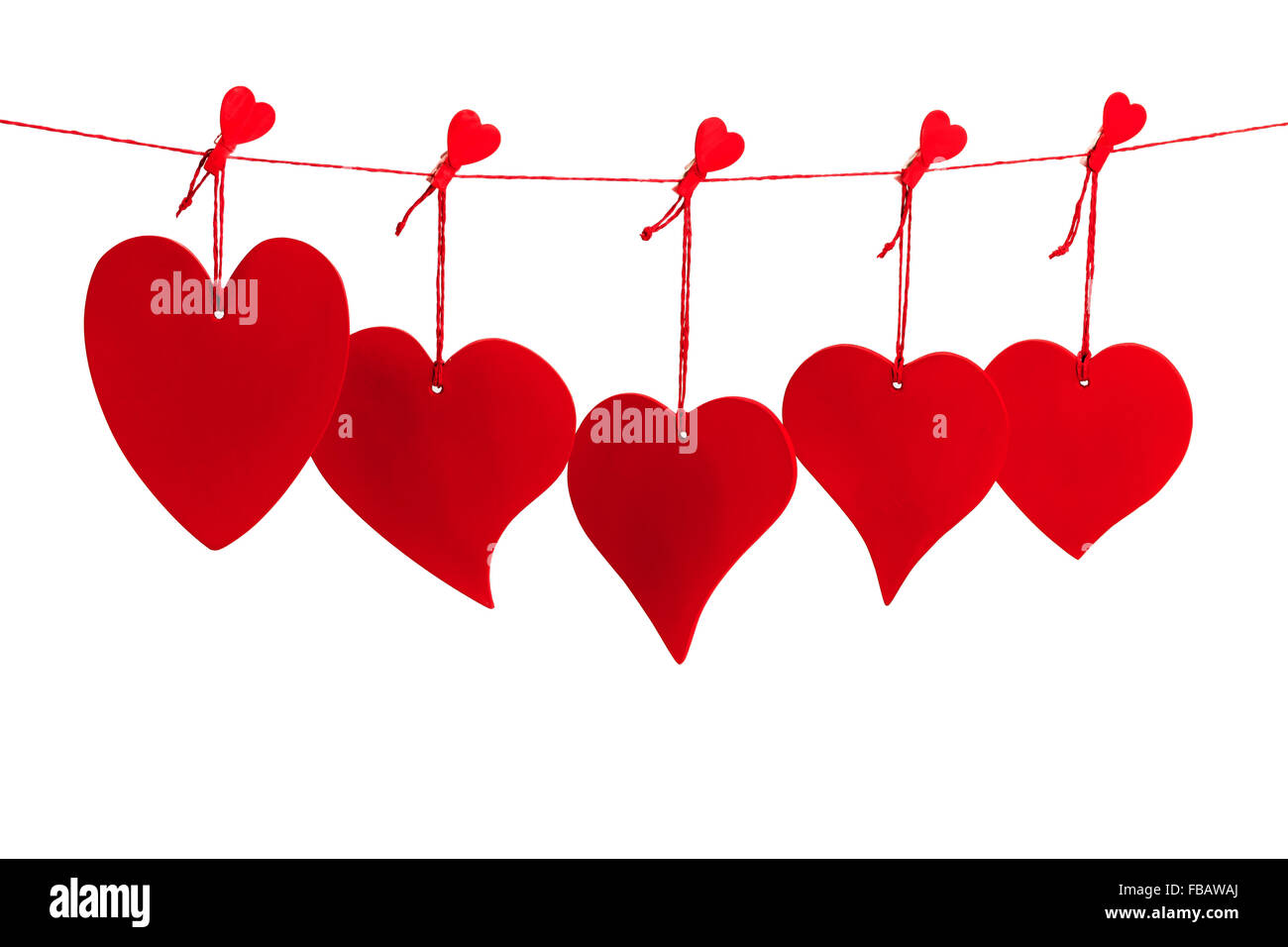 Five red valentine hearts hanging from a red string line isolated on ...