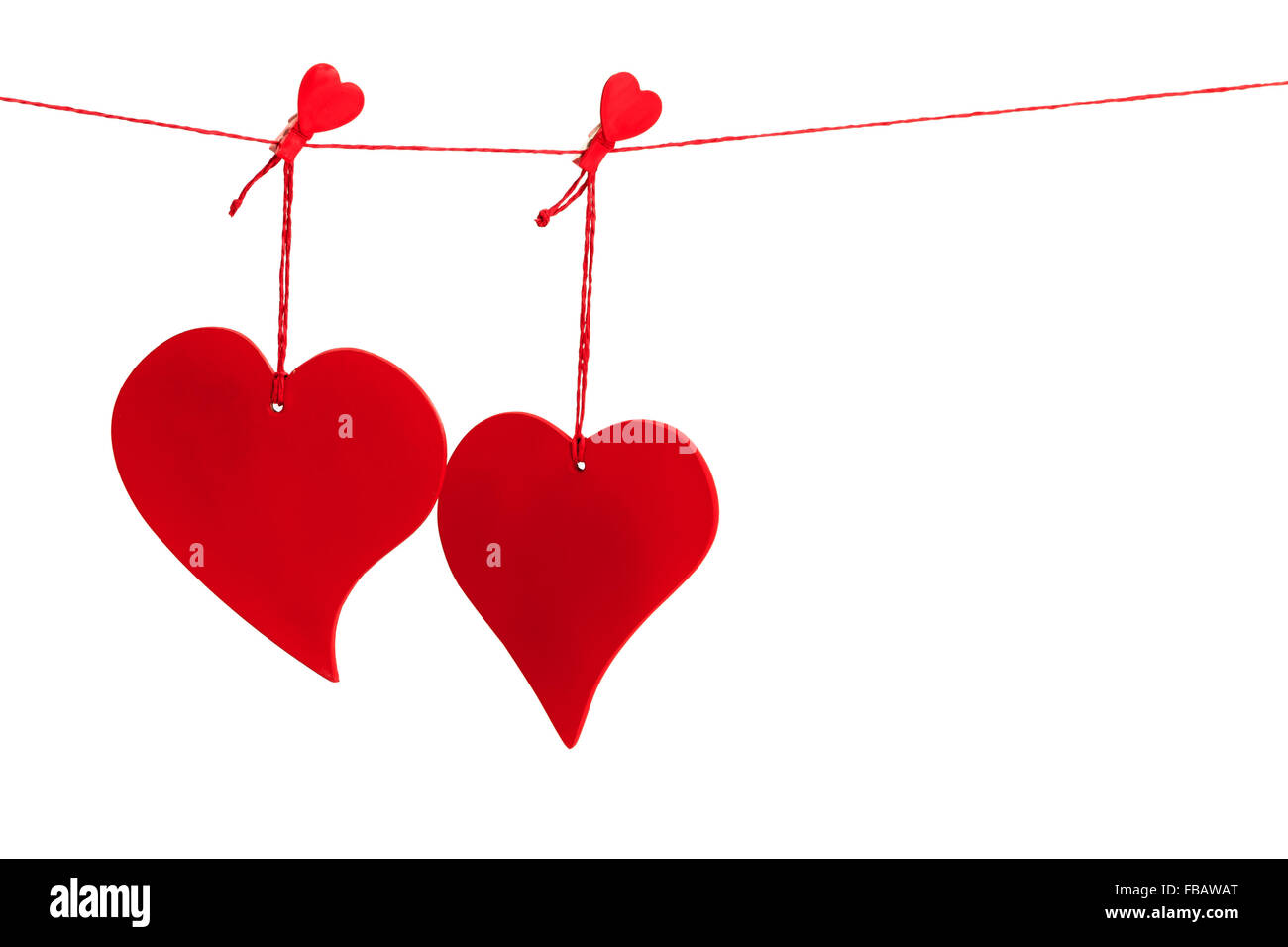 Two red valentine hearts hanging from a red string line isolated on ...