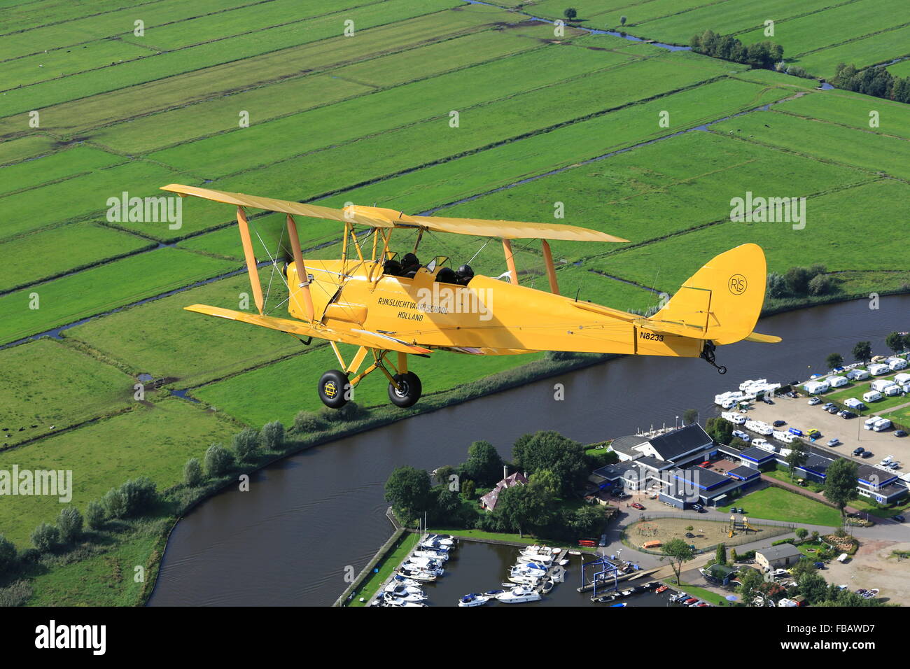 A de Havilland Tiger Moth bi-plane over the Dutch countryside Stock ...
