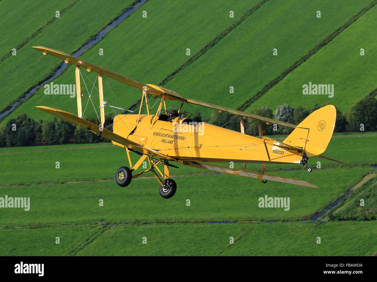 A de Havilland Tiger Moth bi-plane over the Dutch countryside Stock ...