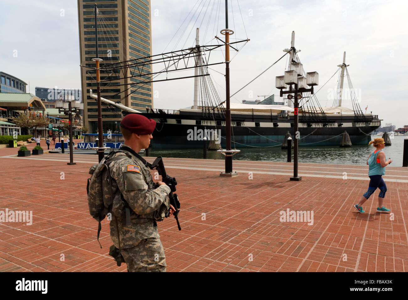 A National Guardsman in Baltimores's inner harbor, by the U.S.S ...