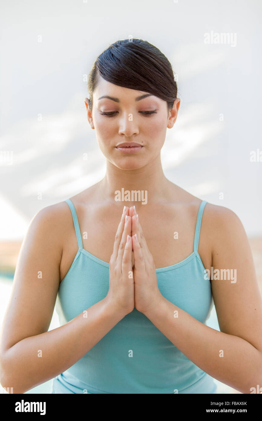 Portrait of a young woman with folded hands Stock Photo - Alamy