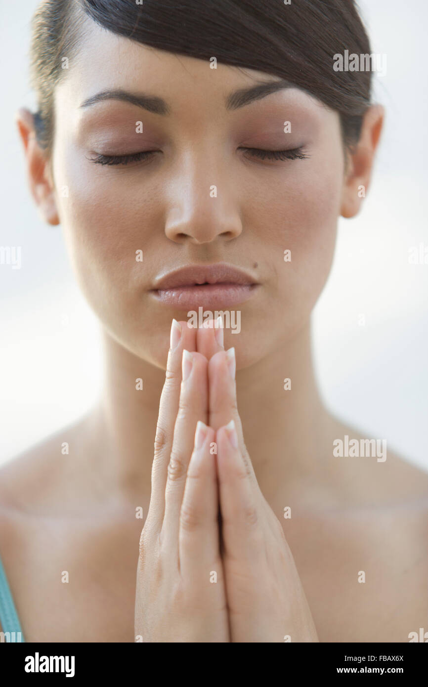 Portrait of a young woman with folded hands Stock Photo - Alamy