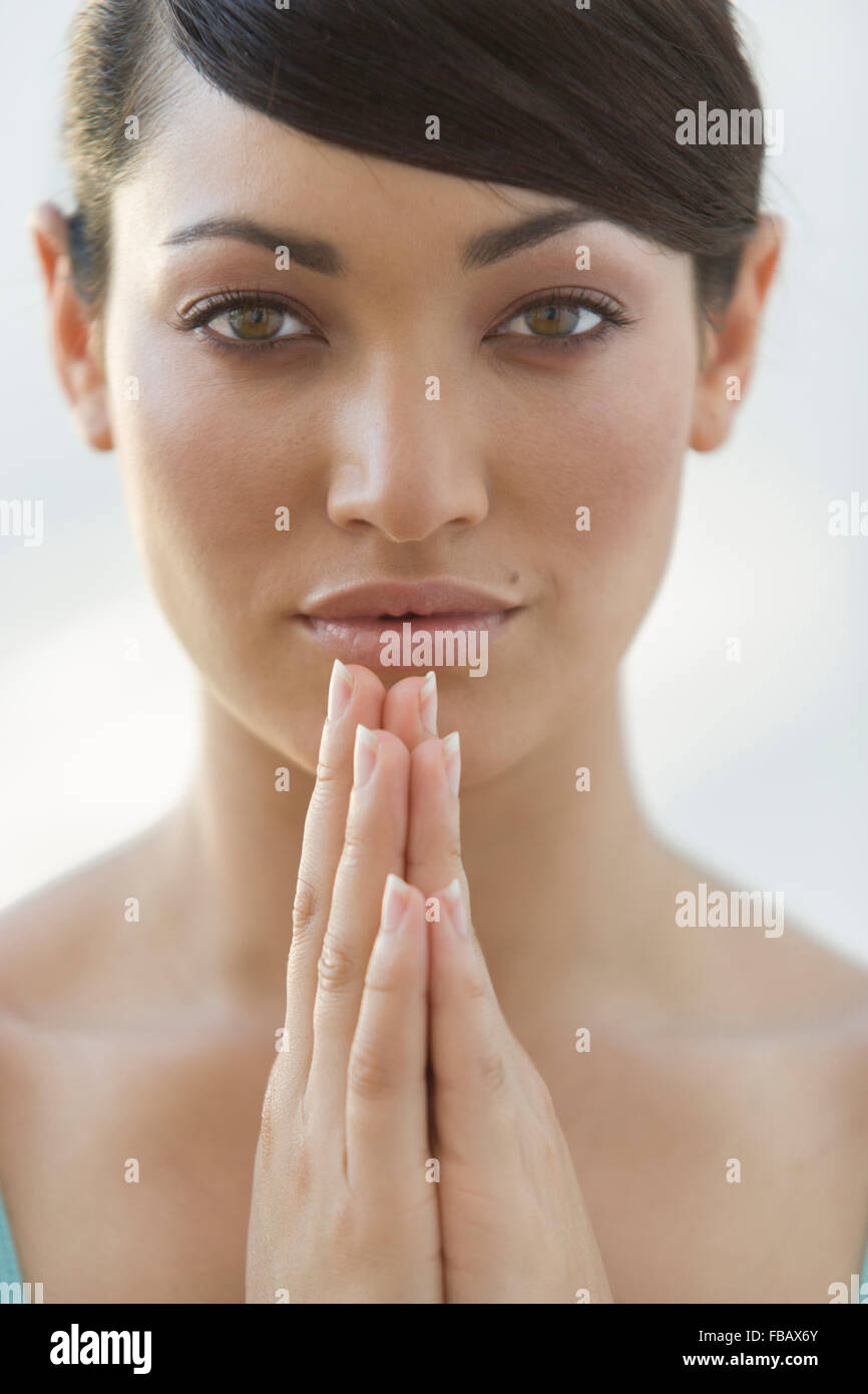 Portrait of a young woman with folded hands Stock Photo - Alamy