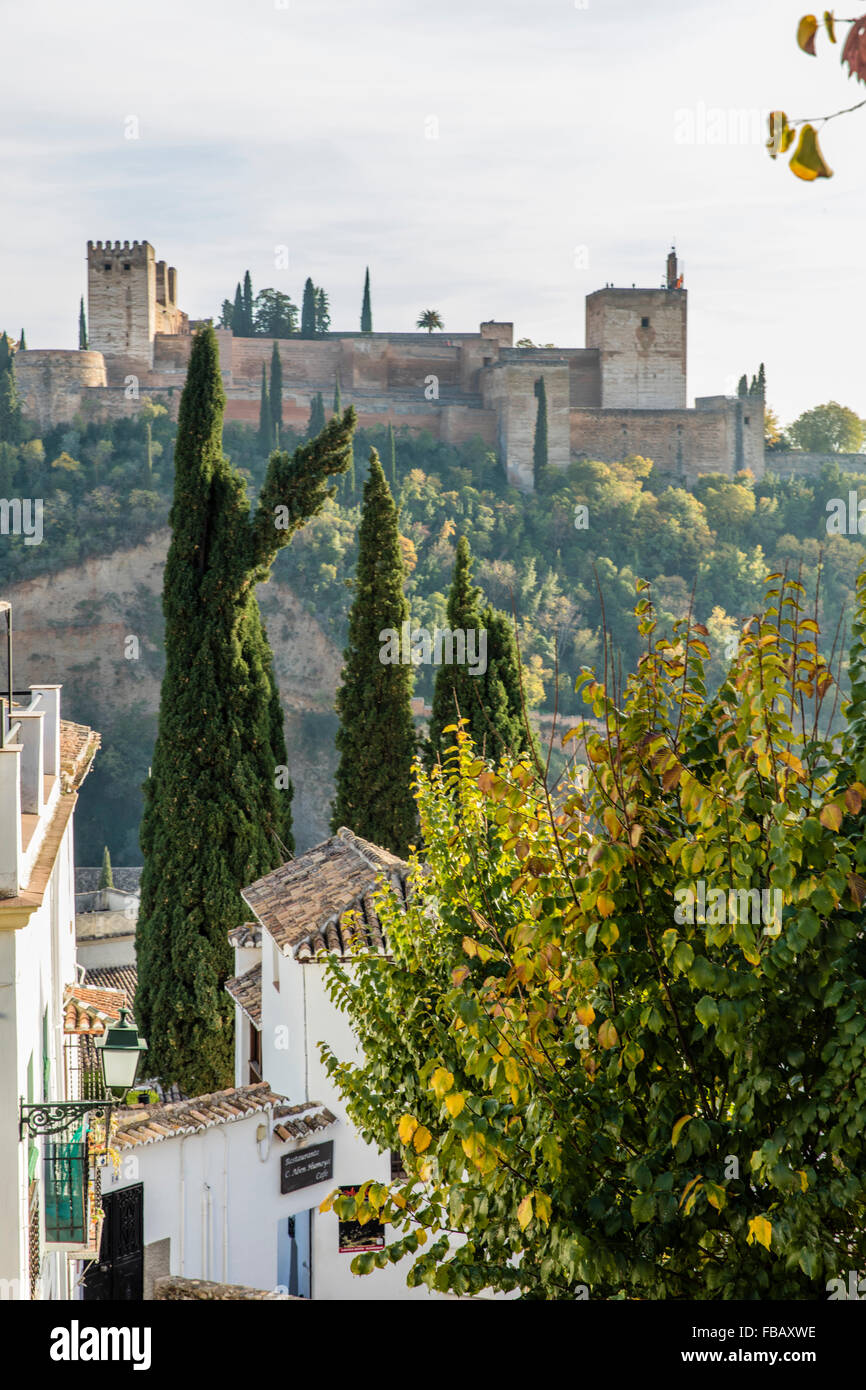 View of the Alhambra Palace from a side street opposite with the sun on ...