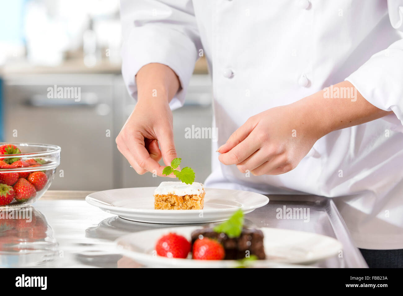 Chef decorate dessert cake with lemon leaf Stock Photo - Alamy
