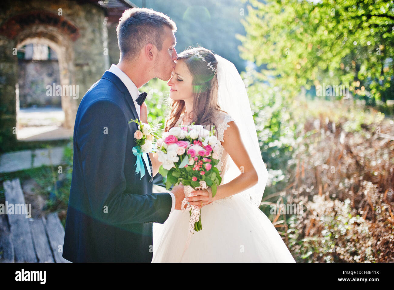 Close up portrait of tender wedding couple on sunset Stock Photo - Alamy