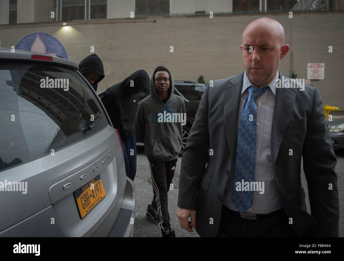 New York, NY, USA. 12th Jan, 2016. An NYPD detective escorts the ...