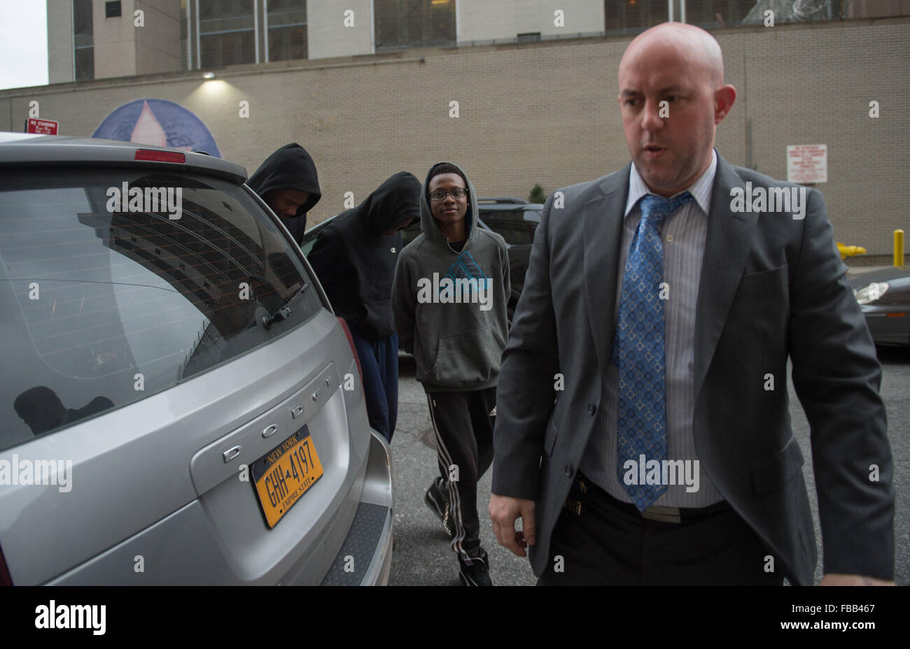 New York, NY, USA. 12th Jan, 2016. An NYPD detective escorts the ...
