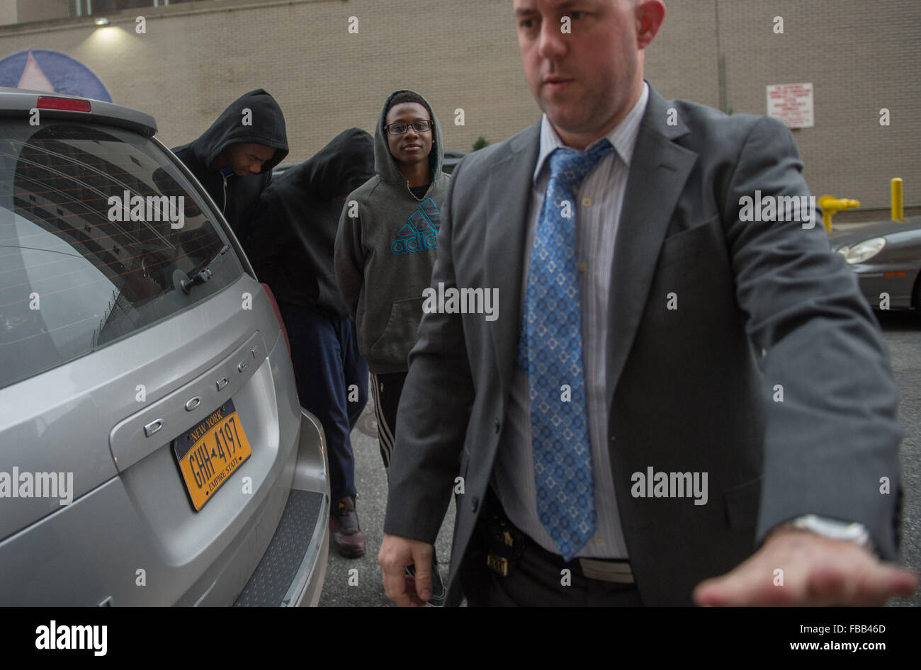 New York, NY, USA. 12th Jan, 2016. An NYPD detective escorts the ...