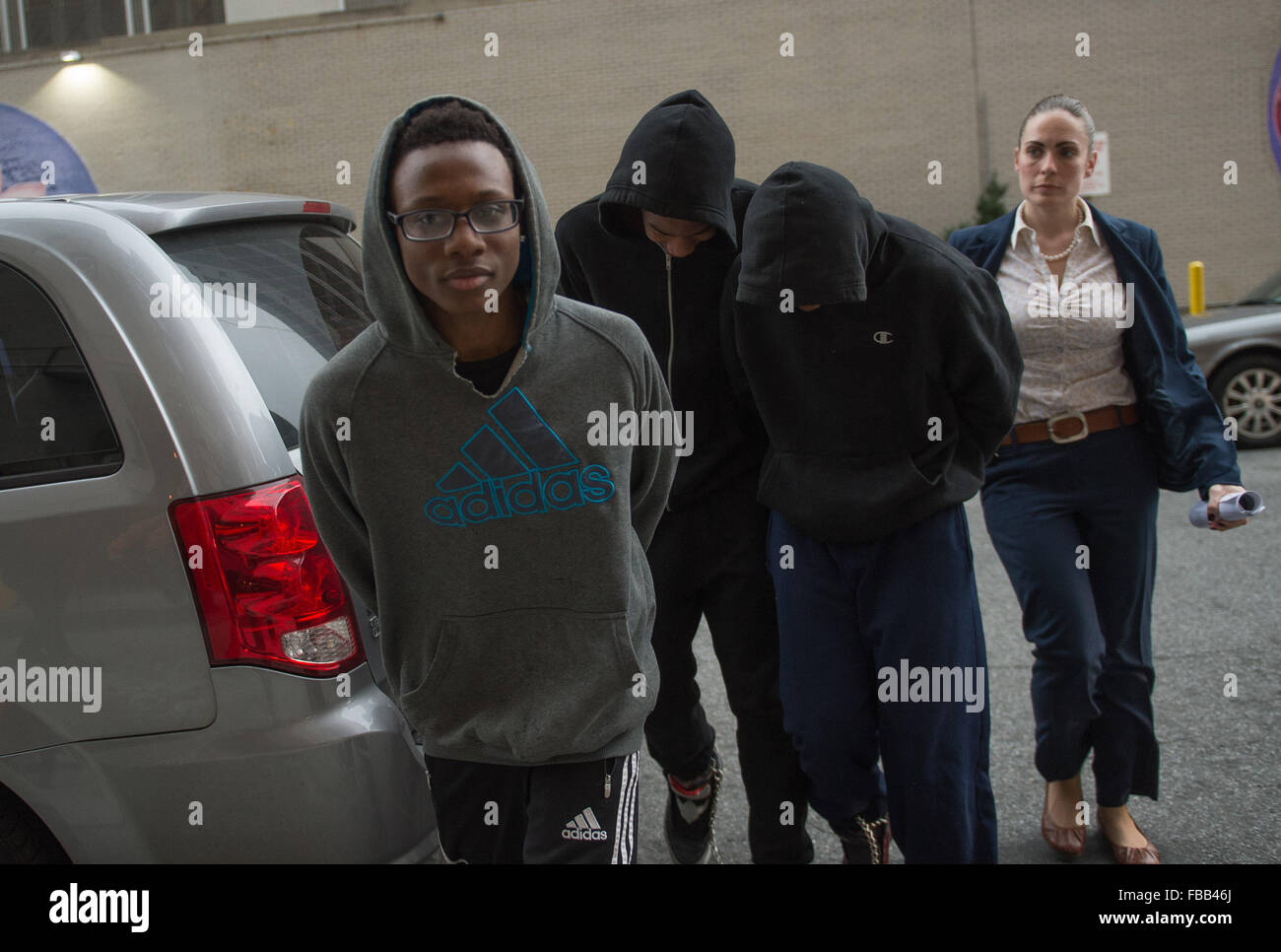 New York, NY, USA. 12th Jan, 2016. An NYPD detective escorts the ...