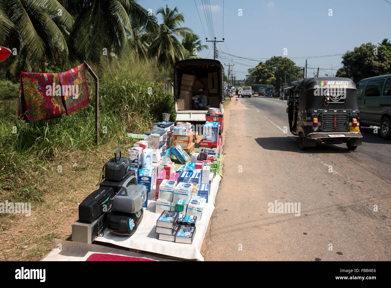 A small roadside market stall selling household electrical goods such ...