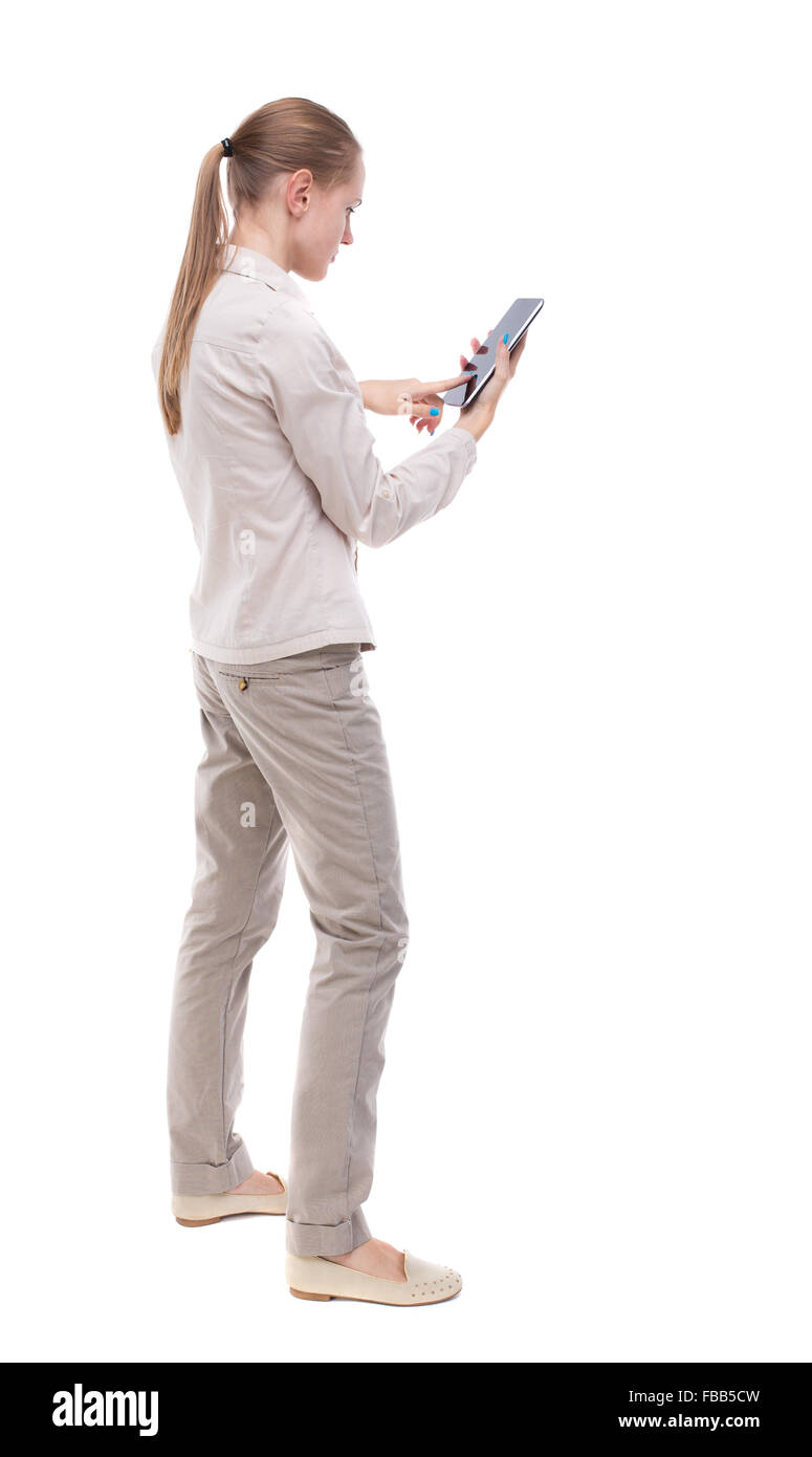 back view of standing young beautiful woman and using a mobile phone ...