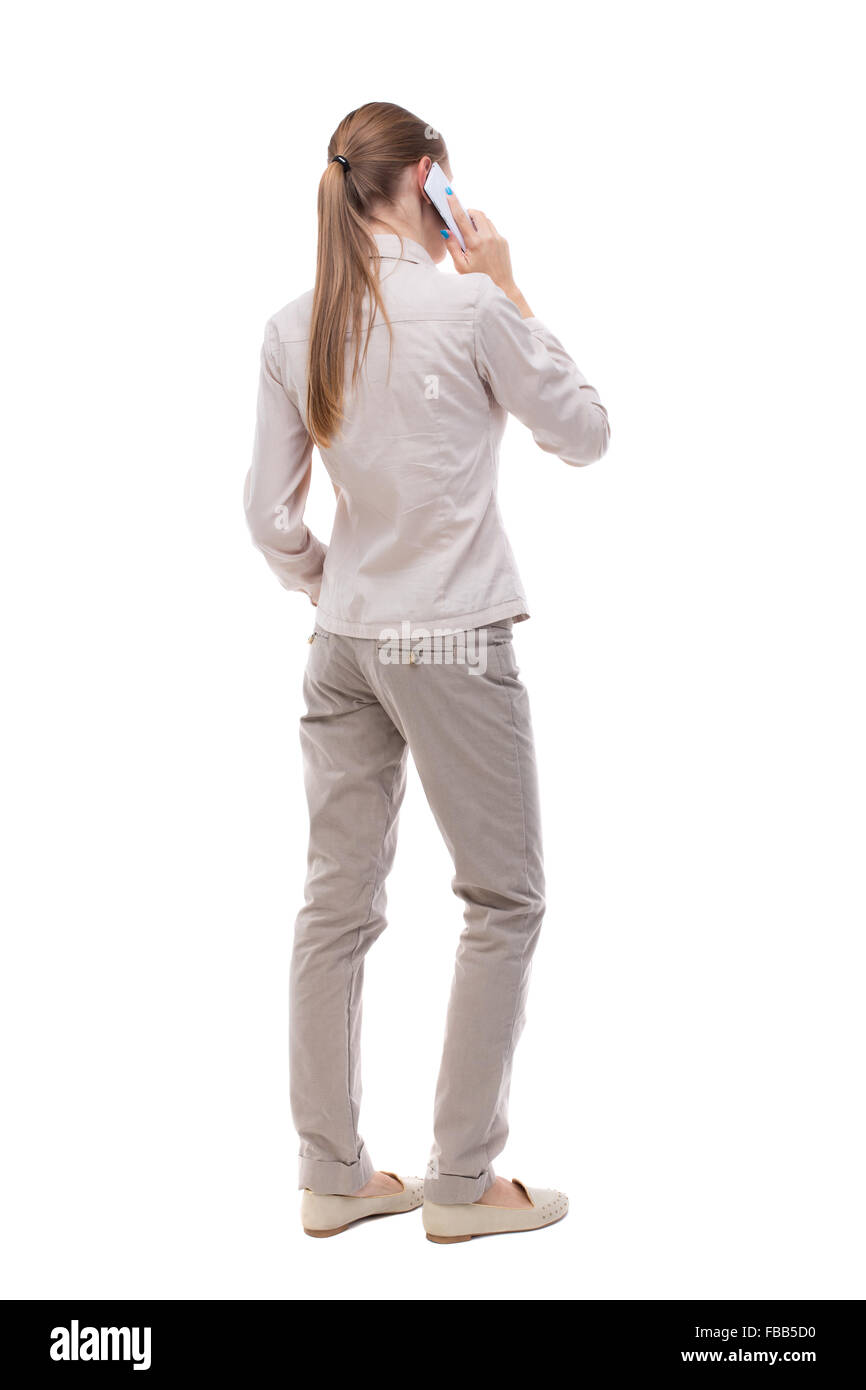back view of a woman talking on the phone. backside view of person ...