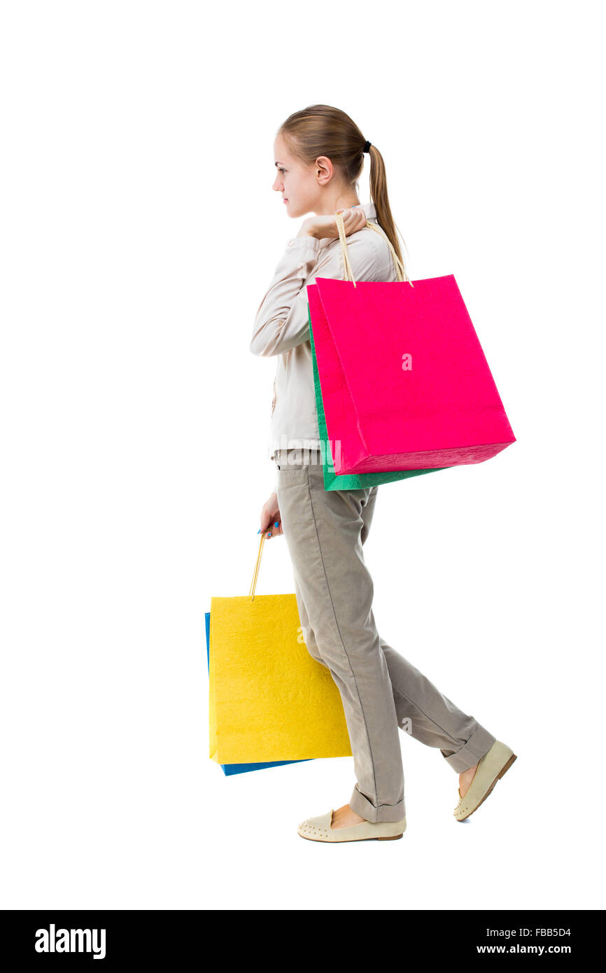 back view of going woman with shopping bags . beautiful girl in motion ...