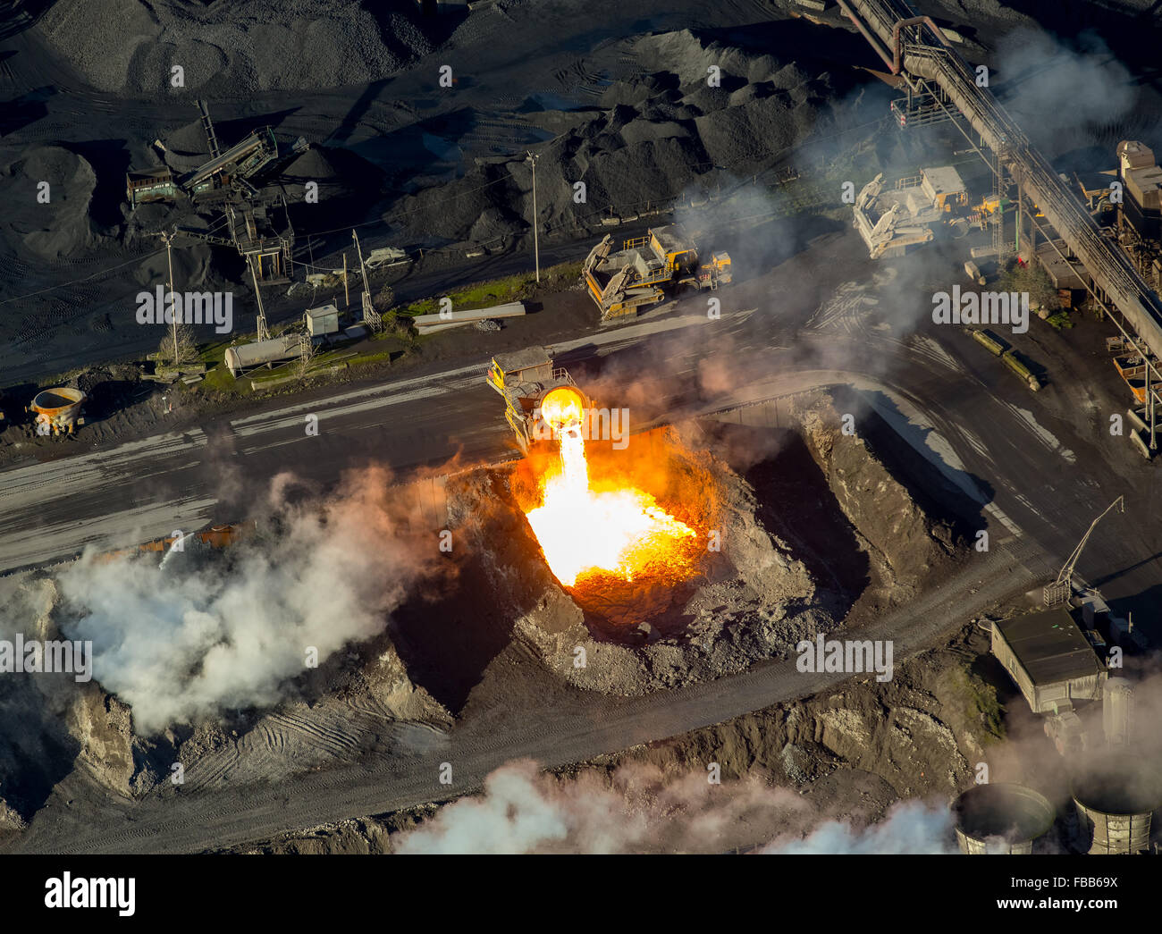 Aerial view, Glowing hot slag from the iron production is tipped from a ...