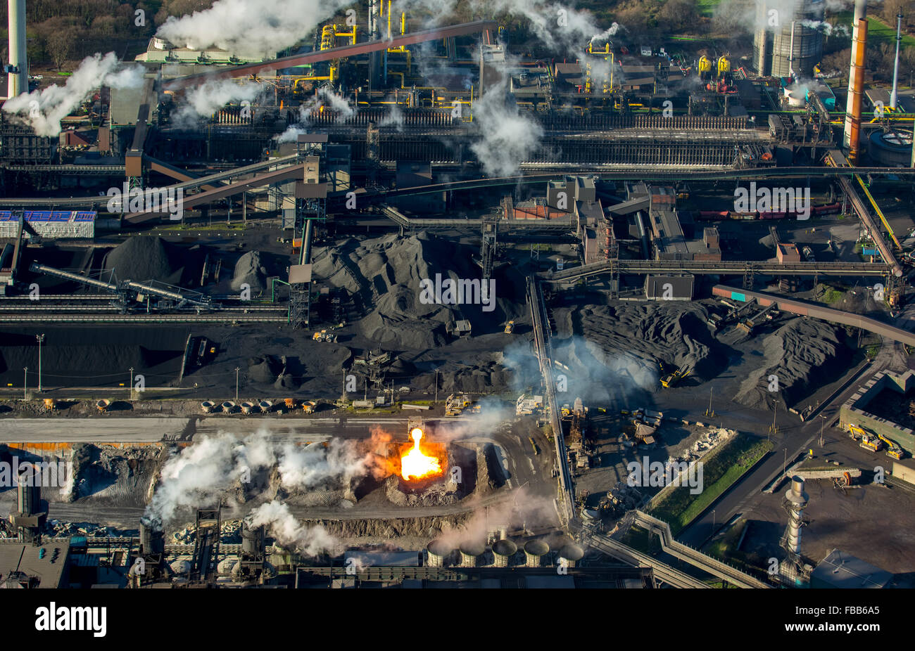 Aerial view, Glowing hot slag from the iron production is tipped from a ...