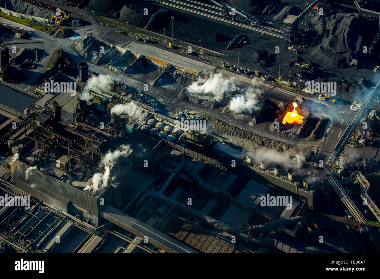 Aerial view, Glowing hot slag from the iron production is tipped from a ...