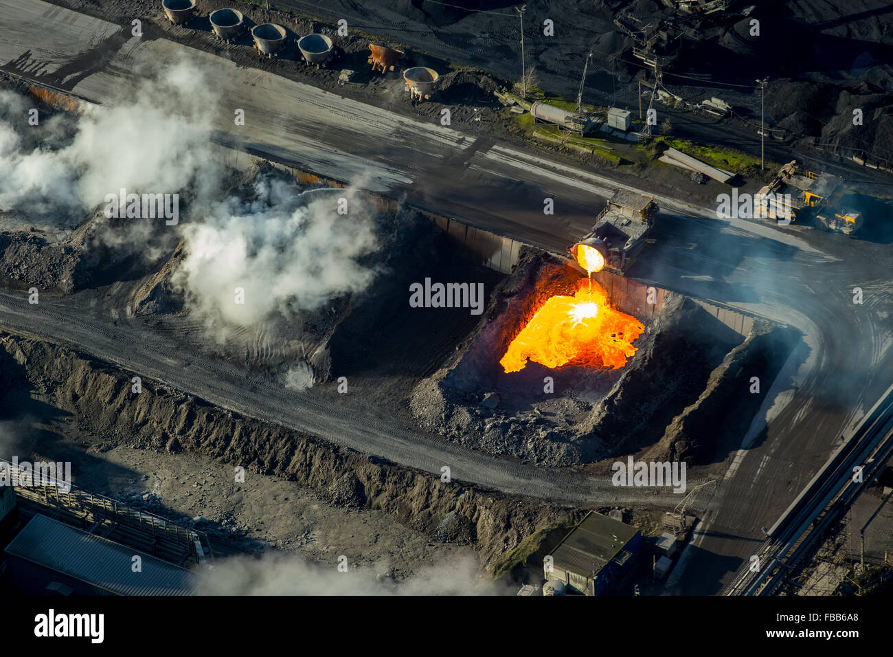 Aerial view, Glowing hot slag from the iron production is tipped from a ...