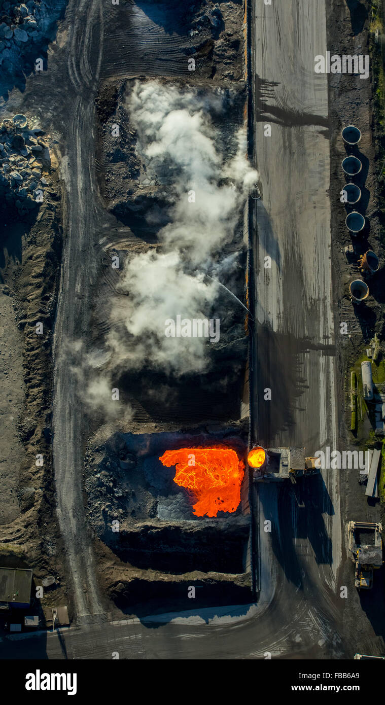 Aerial view, Glowing hot slag from the iron production is tipped from a ...
