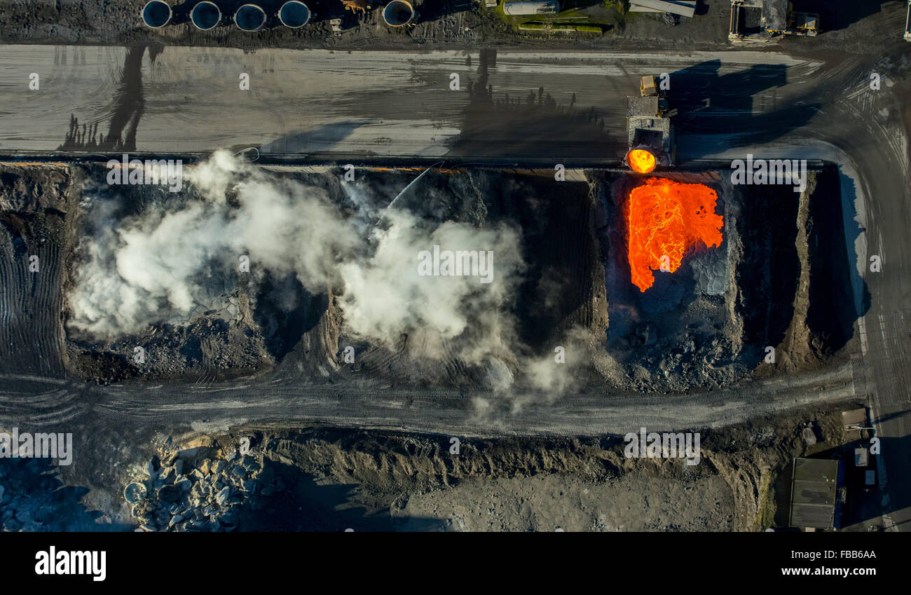 Aerial view, Glowing hot slag from the iron production is tipped from a ...