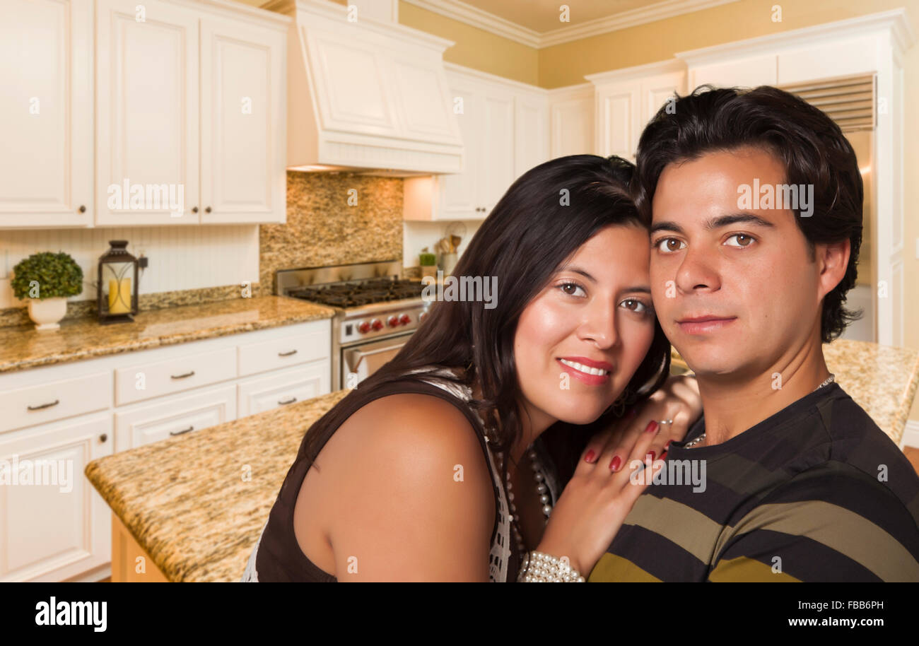 Affectionate Hispanic Couple Inside Custom Kitchen Interior Stock Photo ...