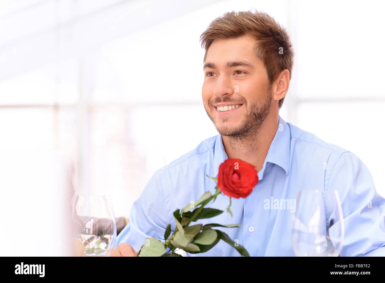 Handsome man holding rose Stock Photo - Alamy