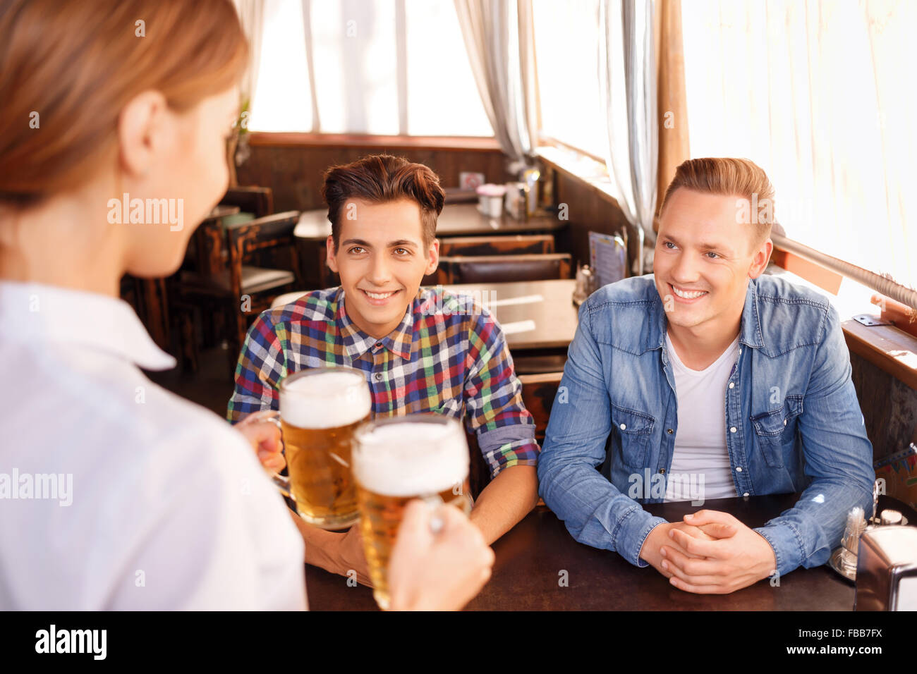 Contented friend drinking beer Stock Photo - Alamy