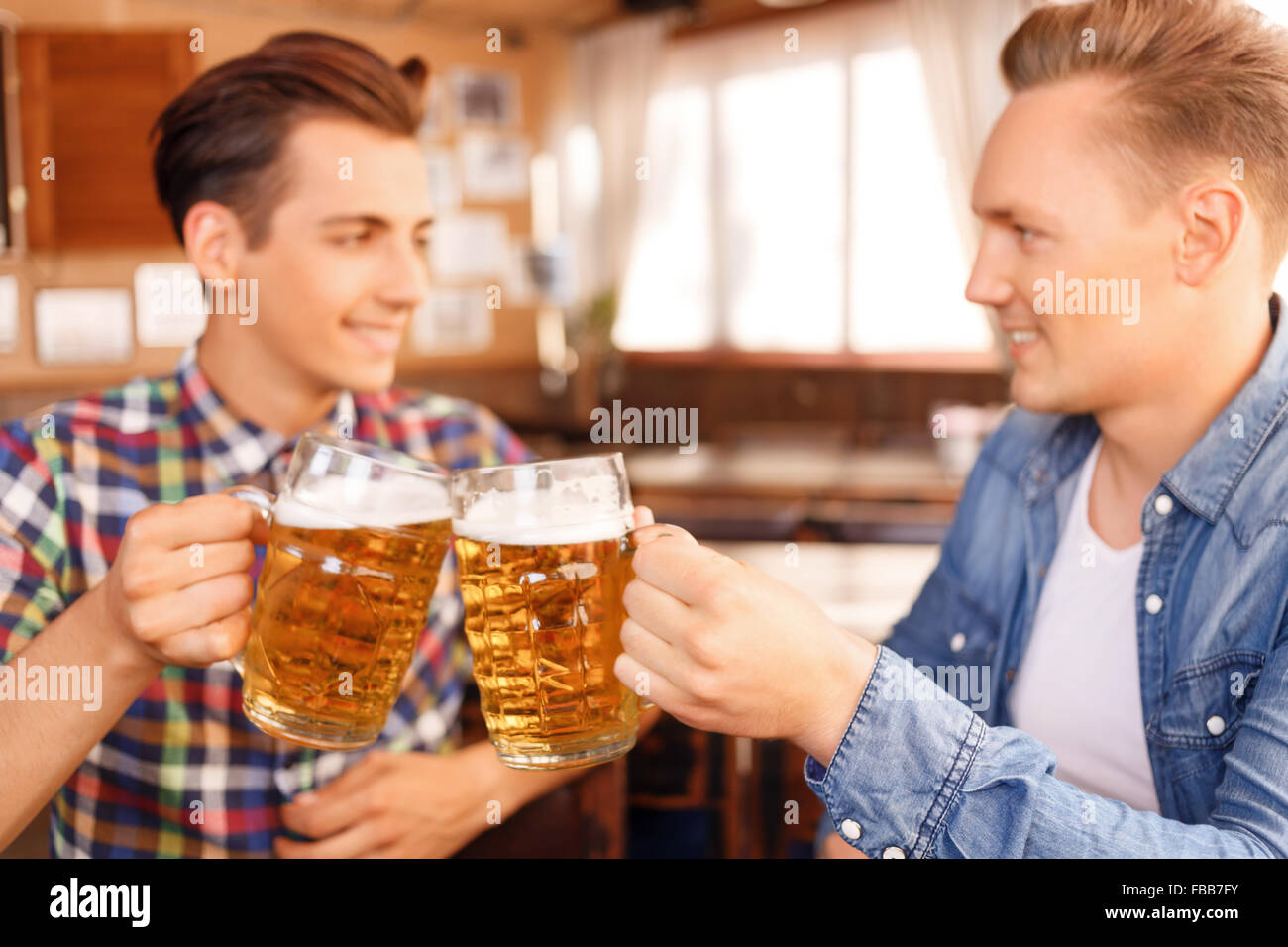 Contented friend drinking beer Stock Photo - Alamy