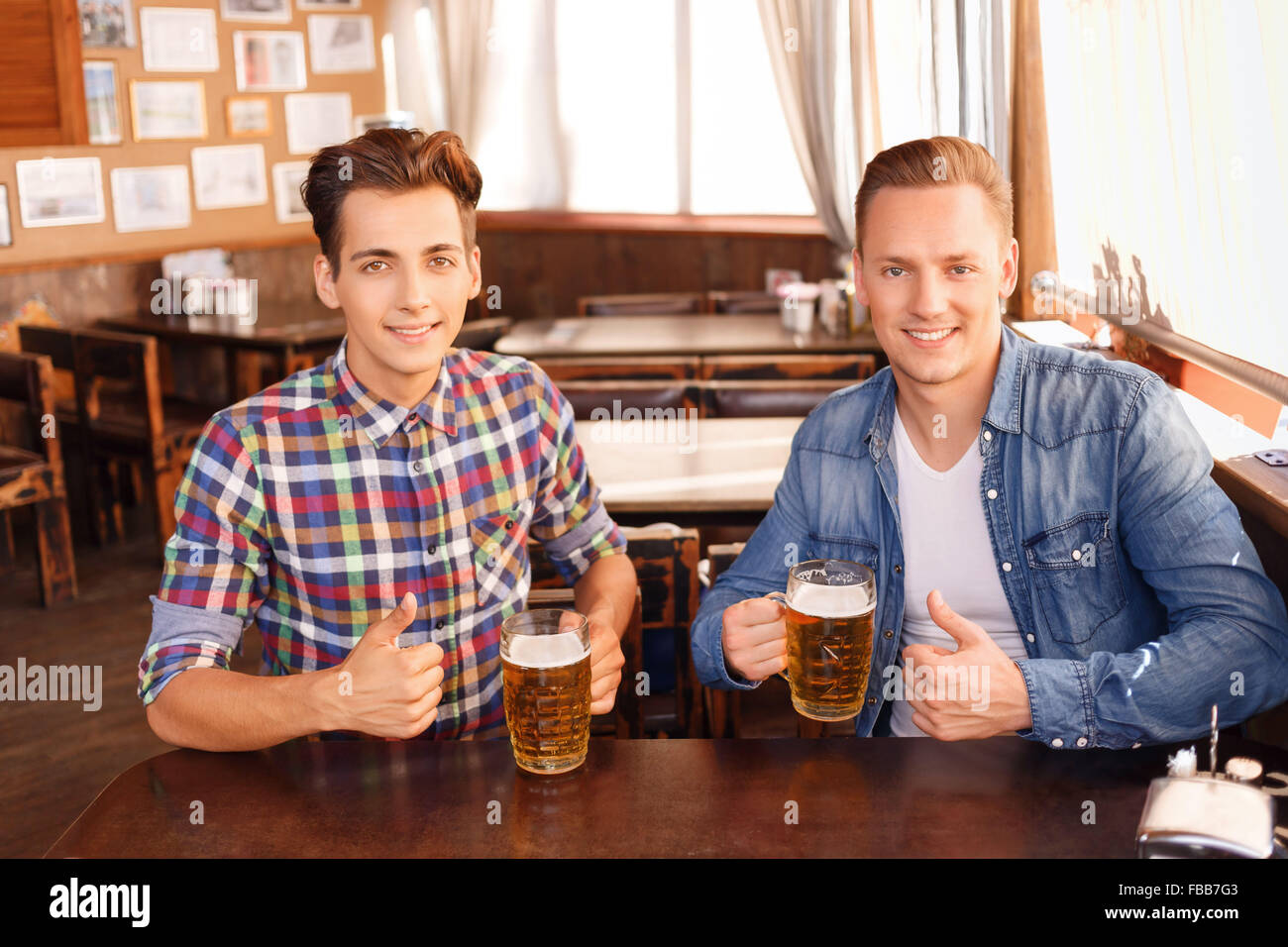 Contented friend drinking beer Stock Photo - Alamy
