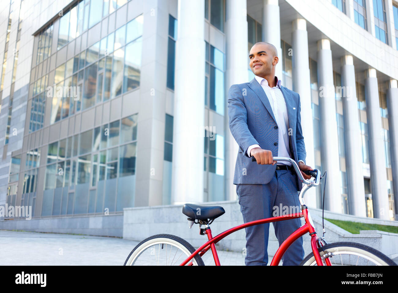 Nice man holding bicycle Stock Photo - Alamy