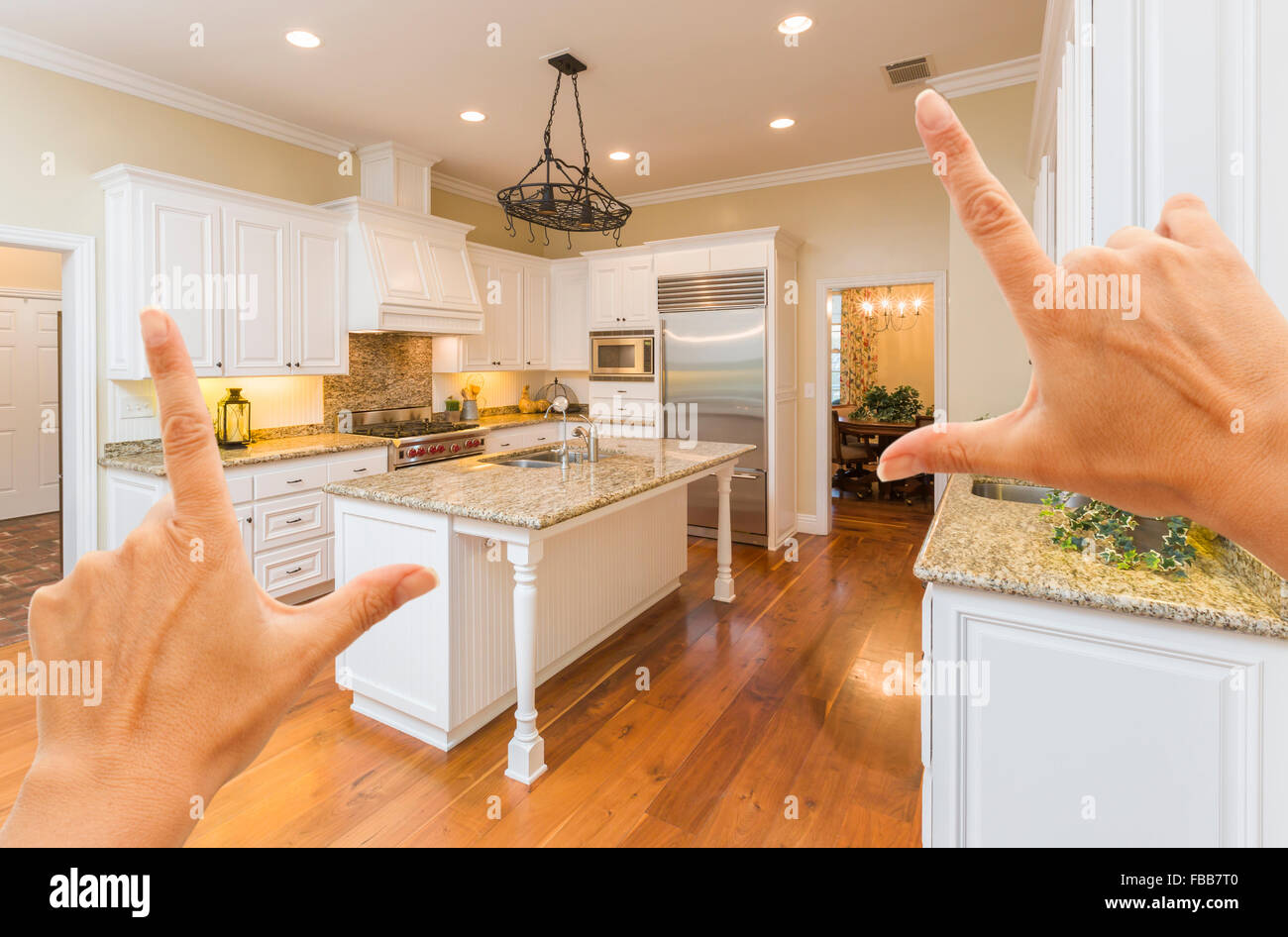 Female Hands Framing A Beautiful Custom Kitchen Interior Stock Photo ...